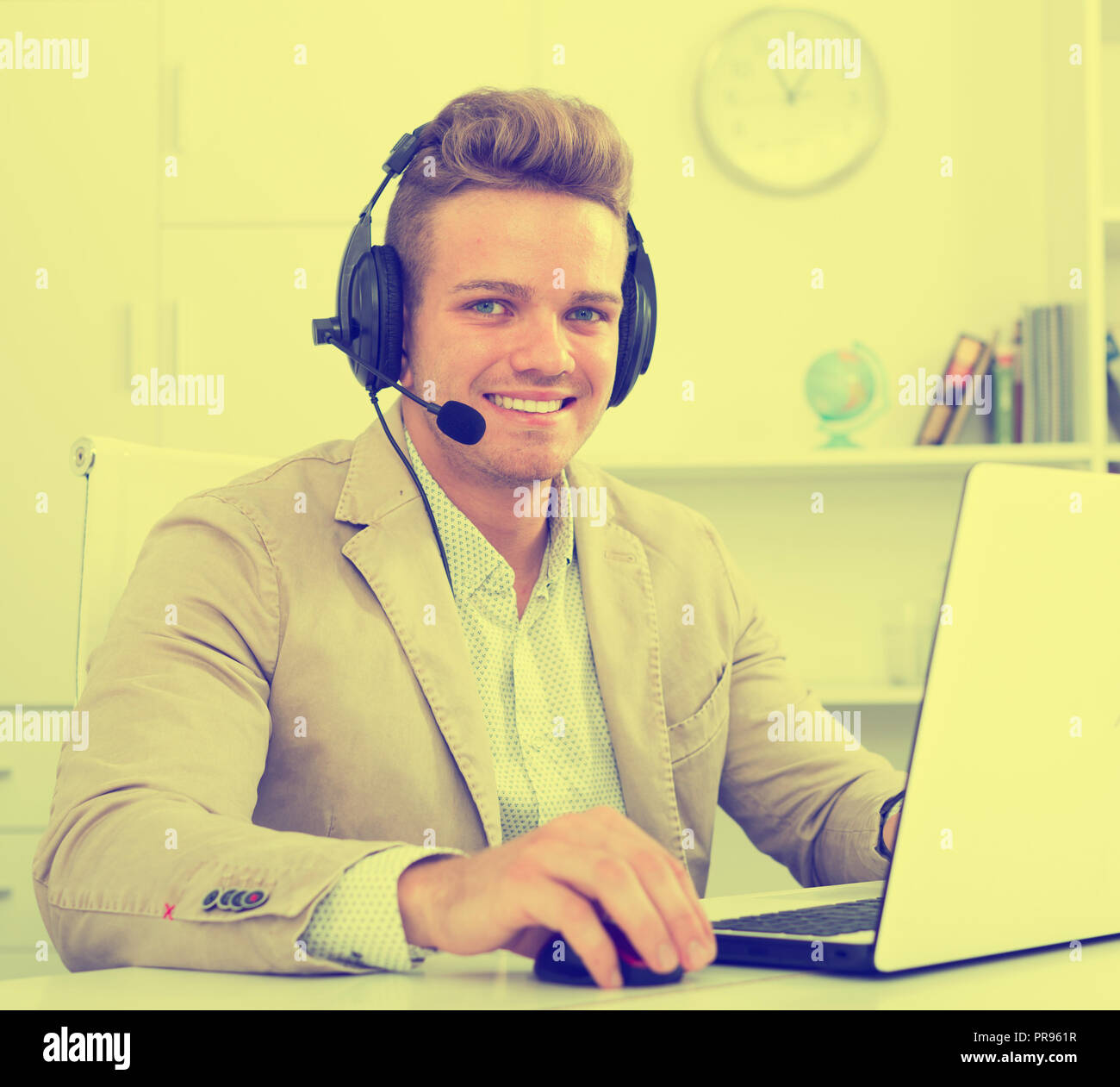 Positive call center male operator talking with client in agency Stock ...