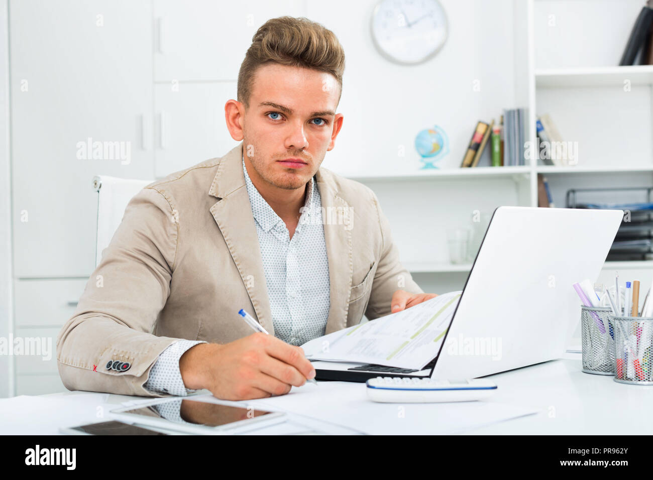 Portrait of diligent businessman working in modern office Stock Photo ...