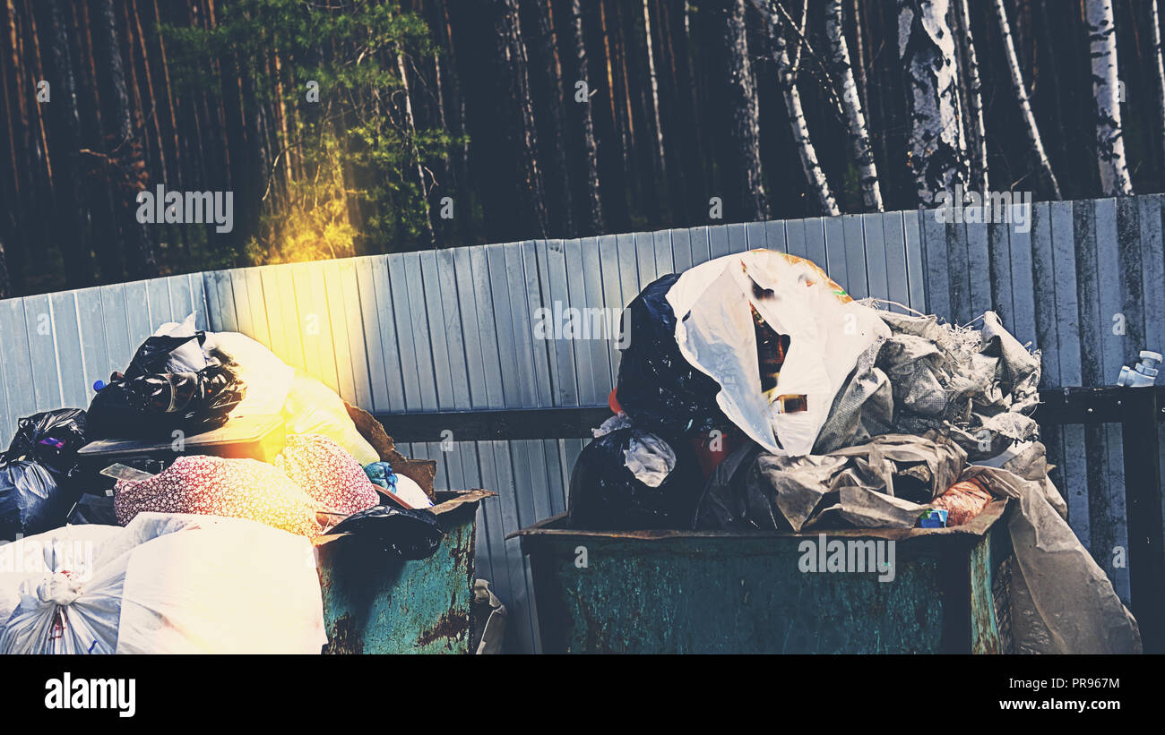 Litter box full of garbage in forest. Concept of ecology problem. Toned ...