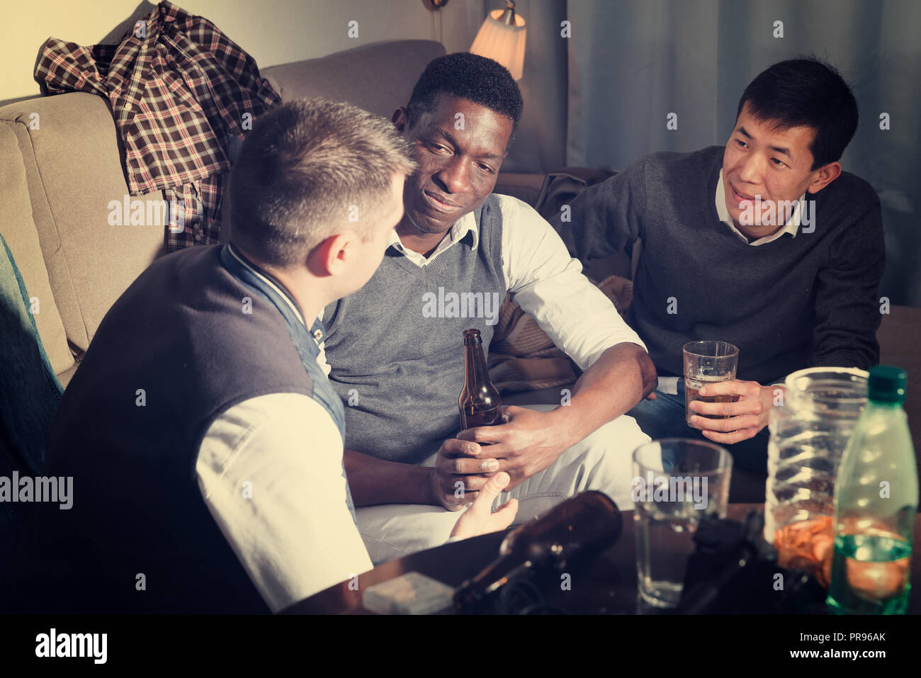 Three friends are talking about life together at home Stock Photo - Alamy