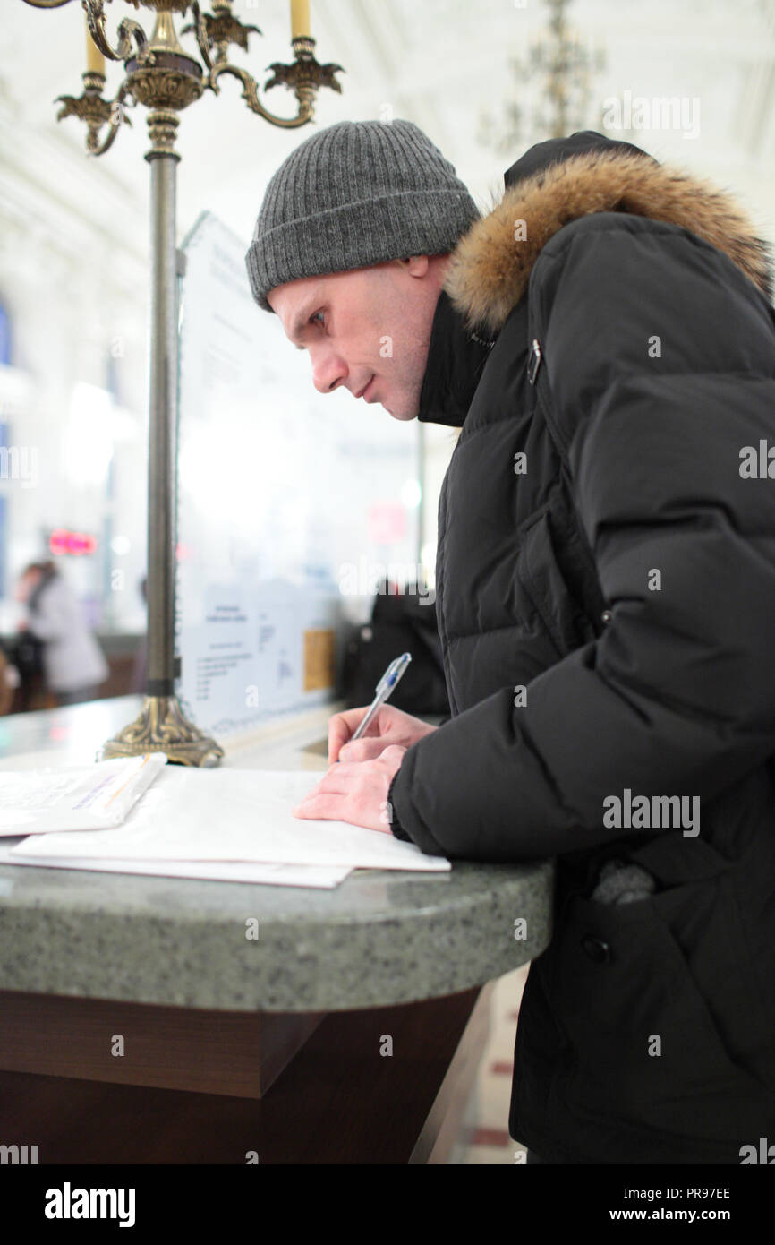 Man write an address on envelope in a post office Stock Photo - Alamy