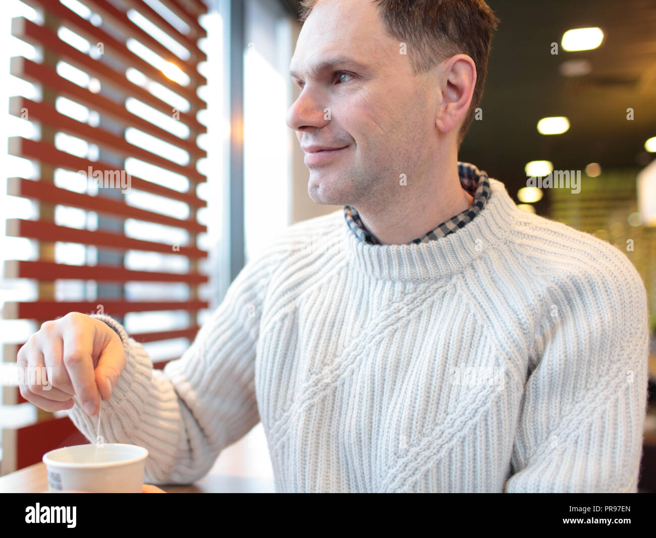 Man drinking tea in a fast food restaurant Stock Photo - Alamy