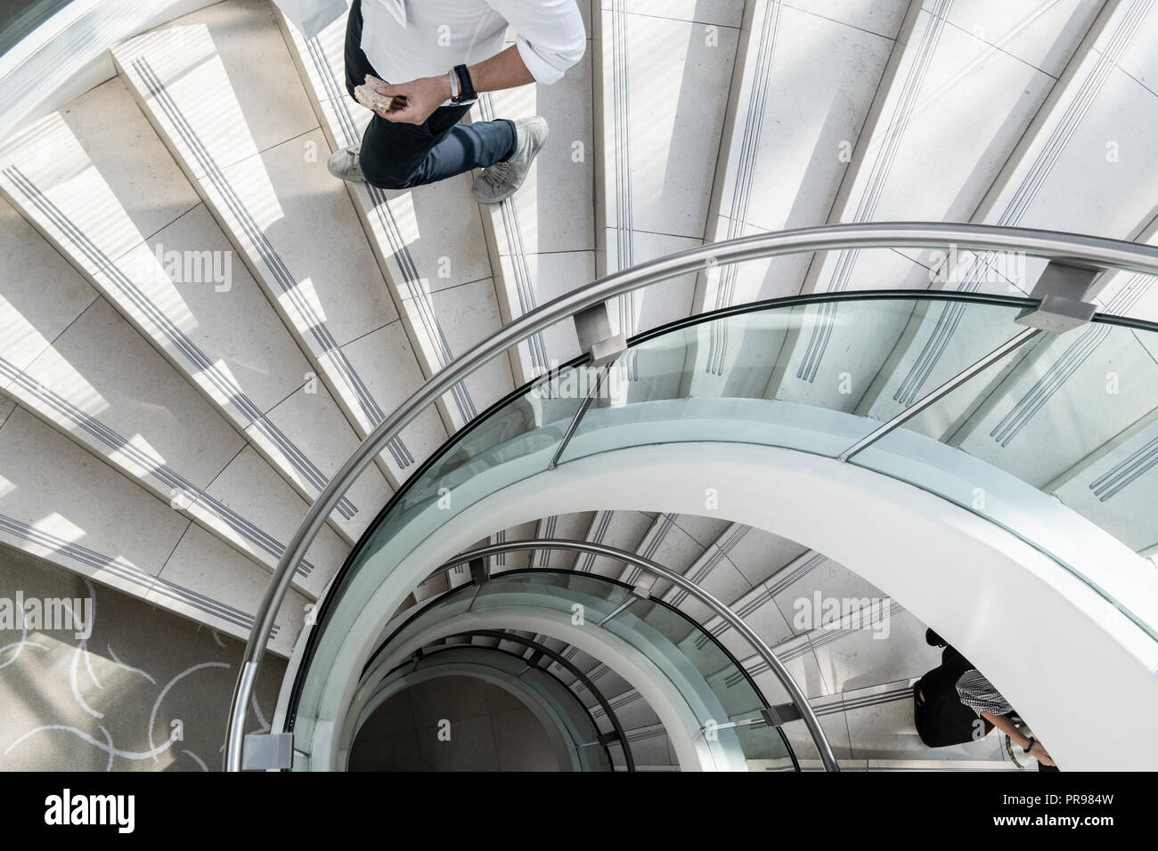 Man descending spiral stairs hi-res stock photography and images - Alamy