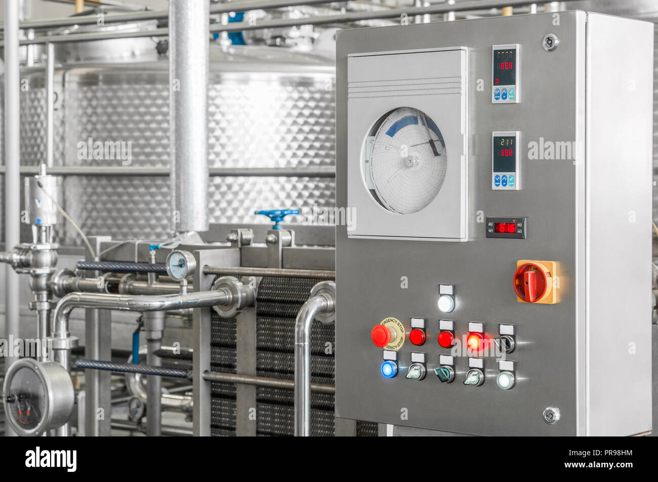 control panel with buttons and a tank at a beverage factory, close-up ...