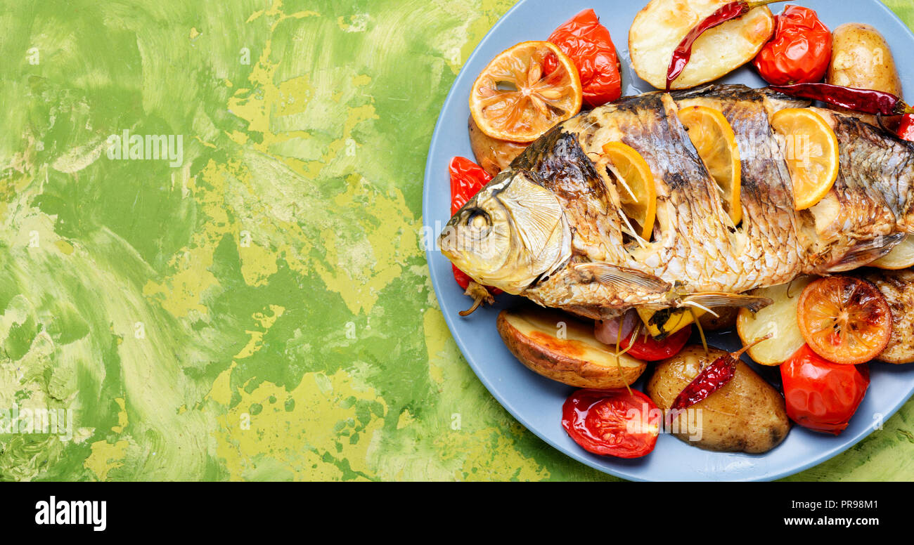 Delicious roasted fish with lemon and garnish.Seafood concept Stock ...