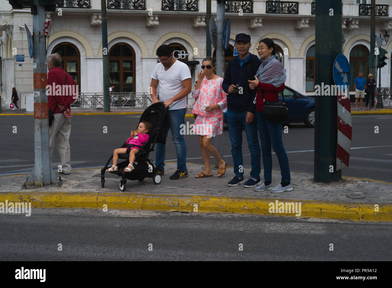 People waiting for the traffic light sign to cross the street in the ...