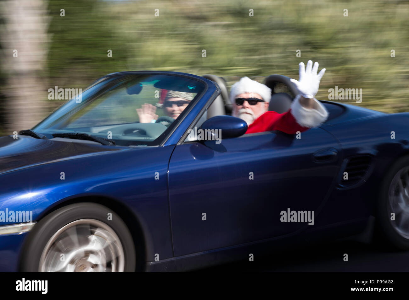 Santa and Mrs. Claus Driving in a convertible while on Vacation in ...