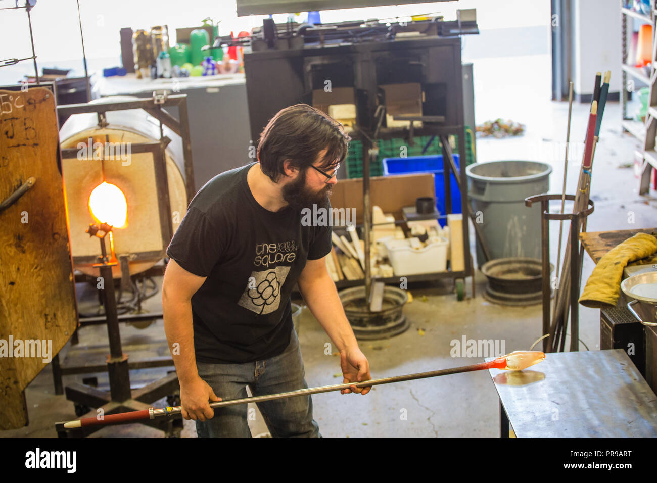 male glass artist letting glass cool off Stock Photo - Alamy