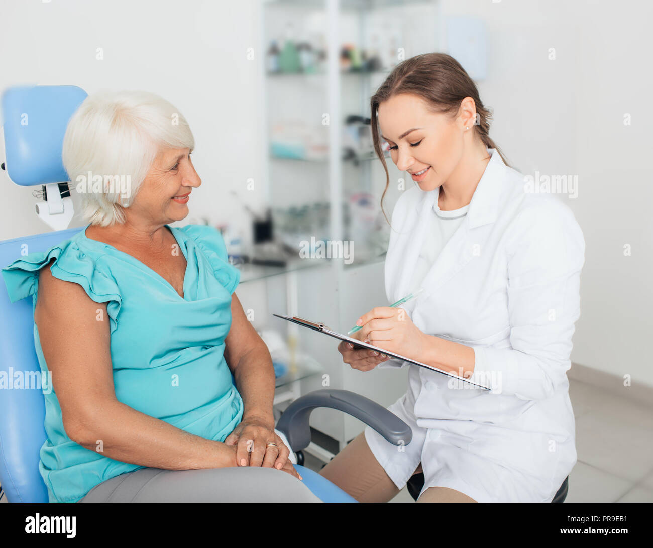 doctor and senior patient reviewing medical chart Stock Photo - Alamy