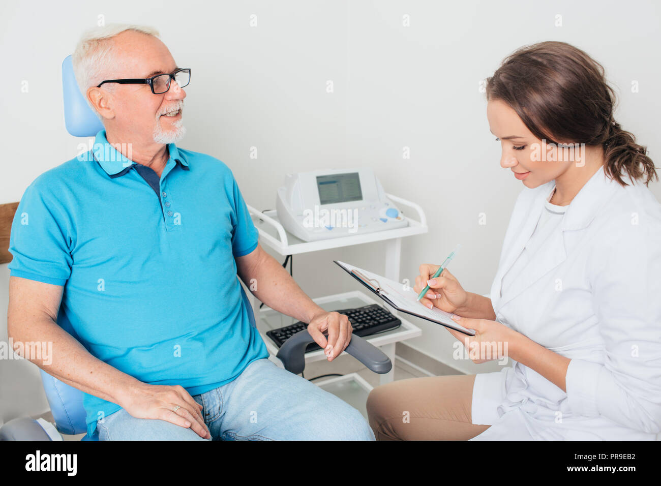 doctor and senior patient reviewing medical chart Stock Photo - Alamy