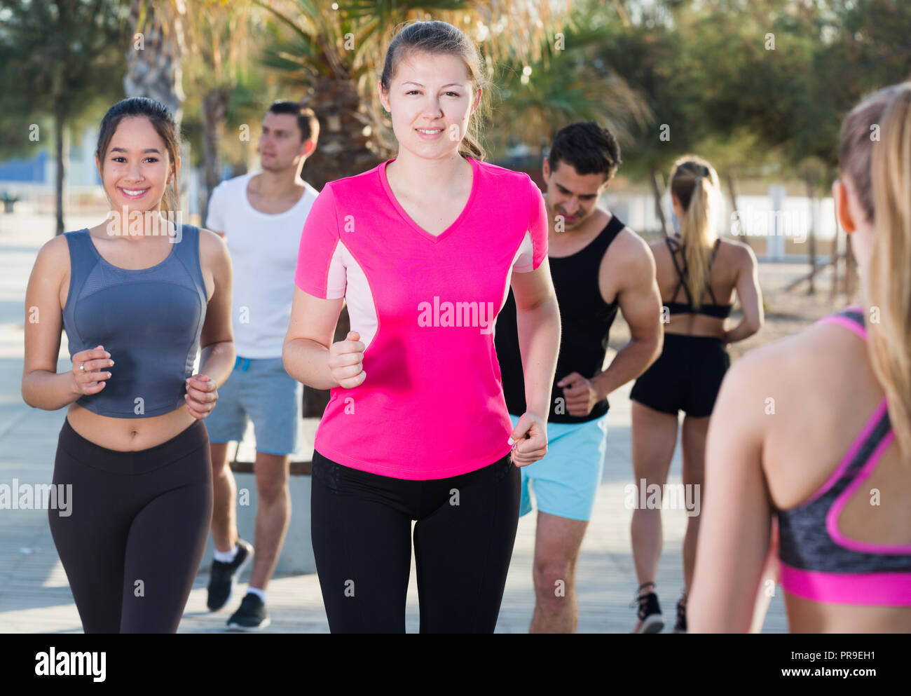 Active smiling people during running training in daytime Stock Photo ...