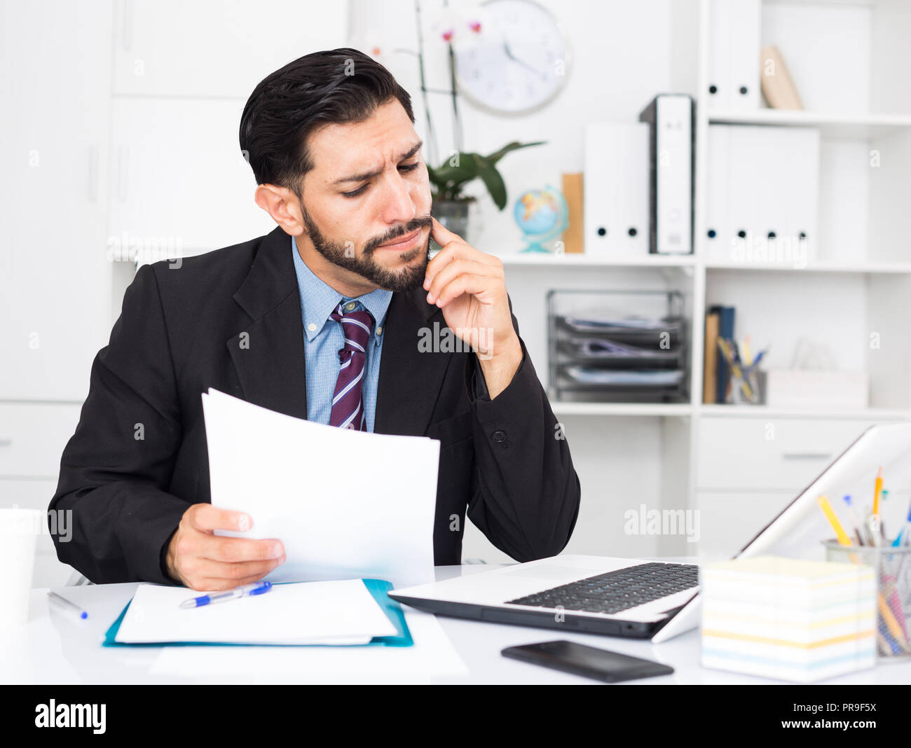 Spanish male worker is having complicated issue with project in office ...