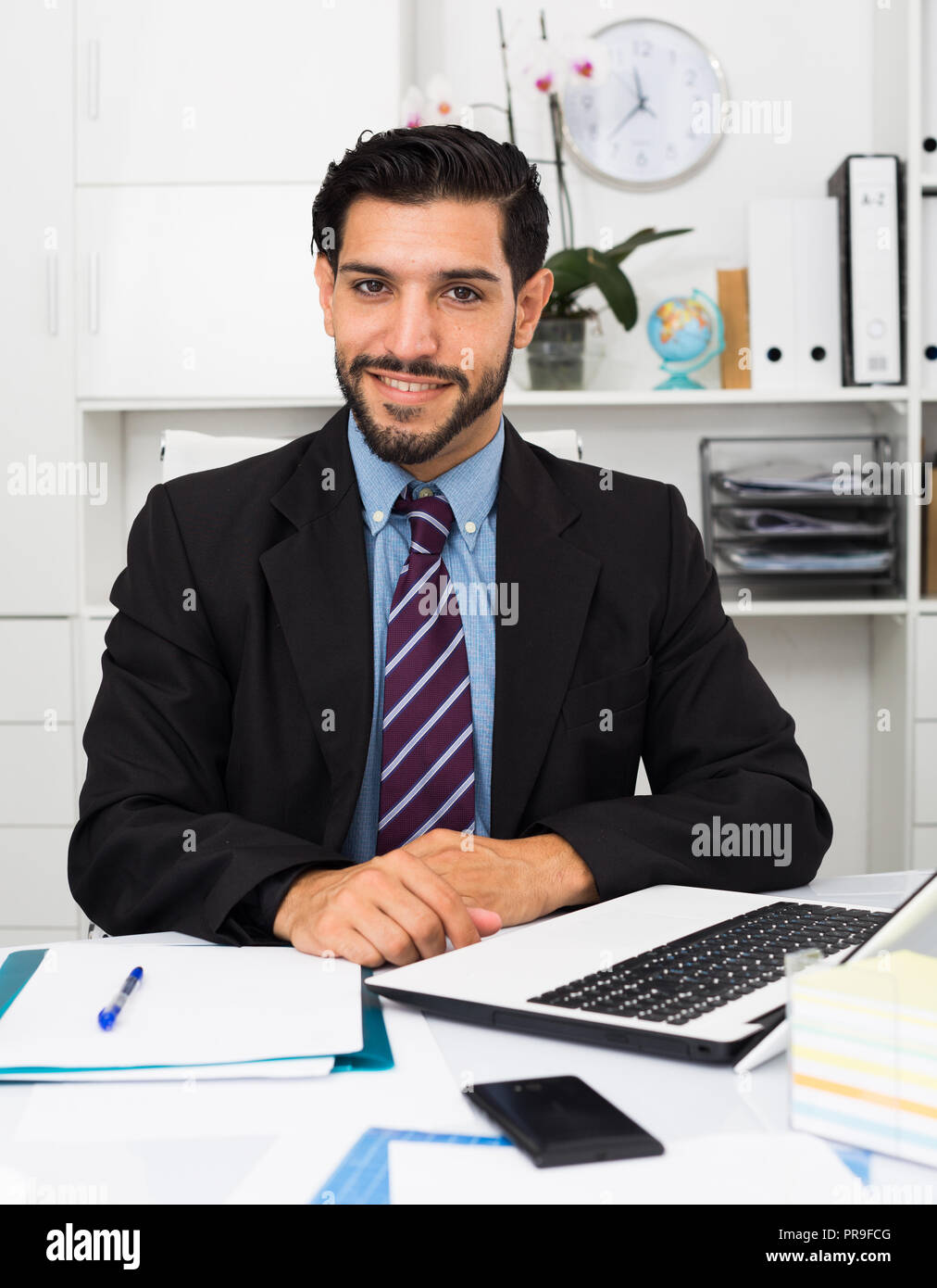 Spanish man is having a productive day at work in office Stock Photo ...