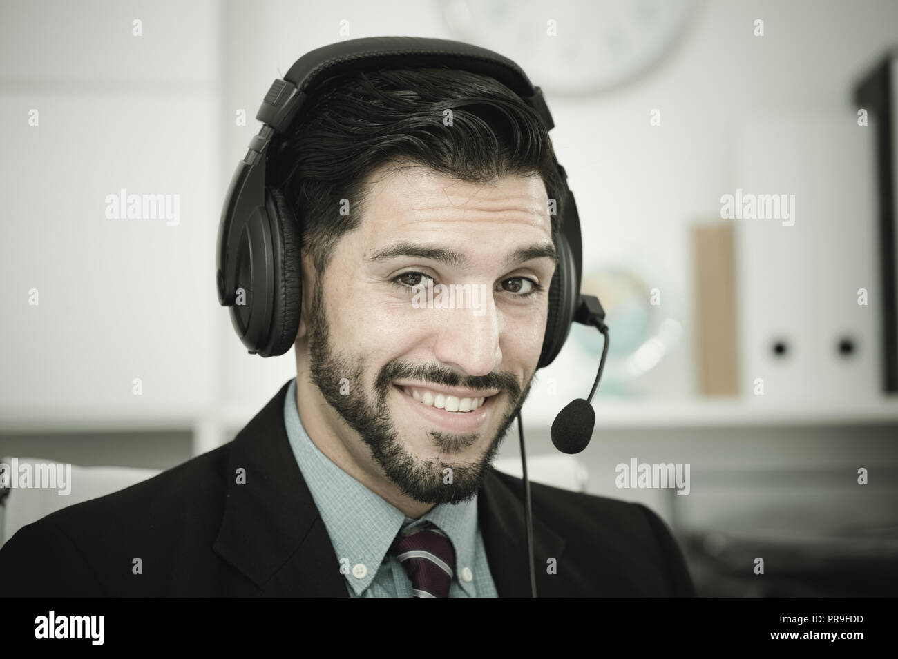 Portrait of spanish man dispatcher who is talking with client in office ...