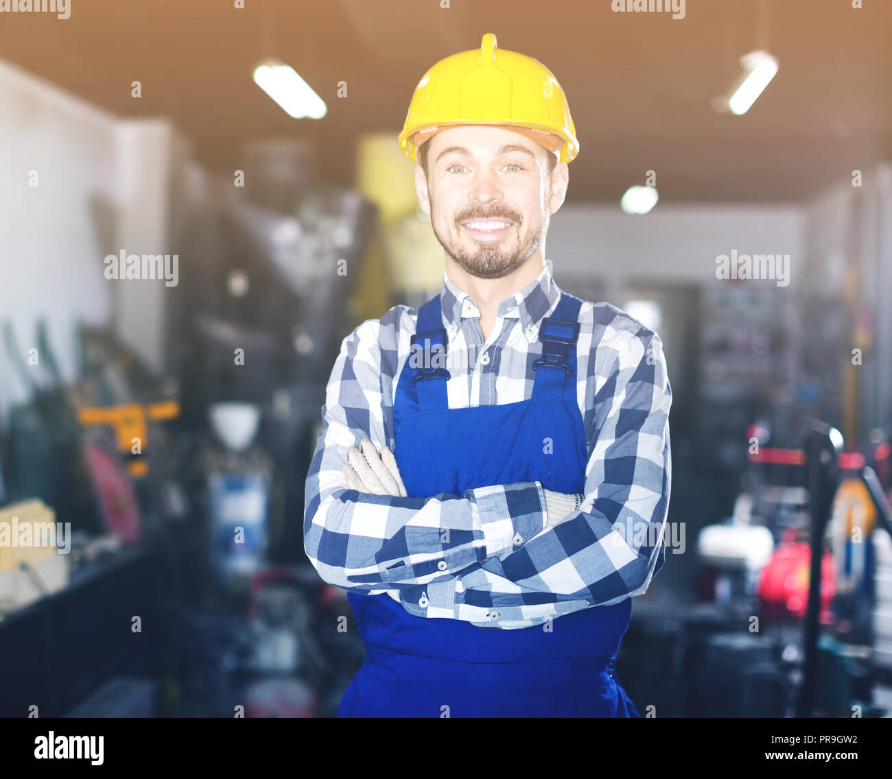 Young male worker showing his workplace and tools at workshop Stock ...