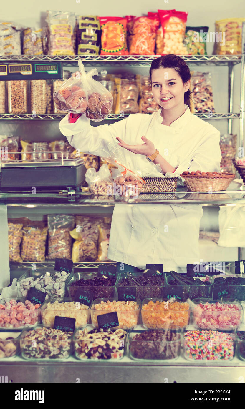 Happy friendly woman selling cookies and other fillings Stock Photo - Alamy