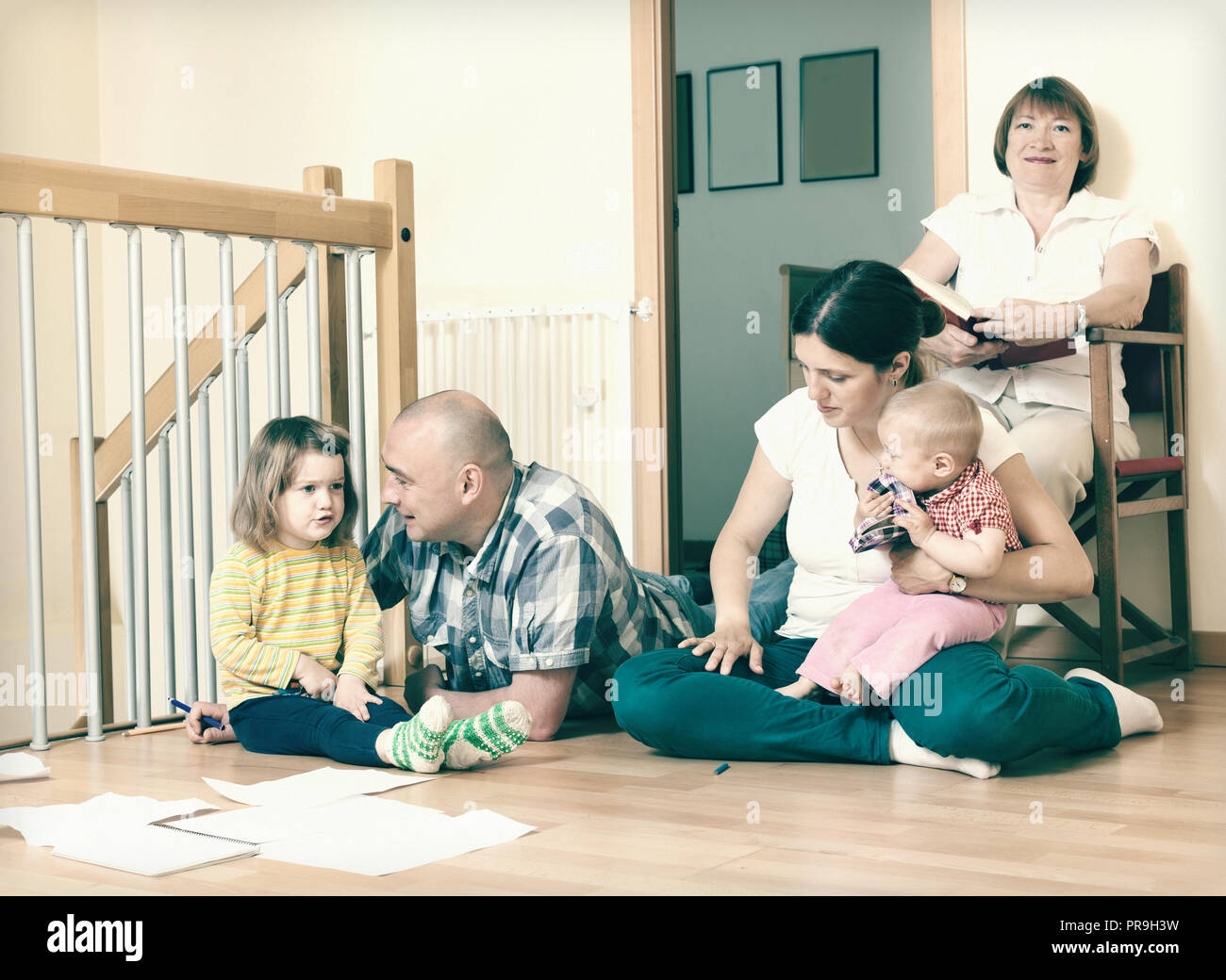 serious three generations family at floor in home Stock Photo - Alamy
