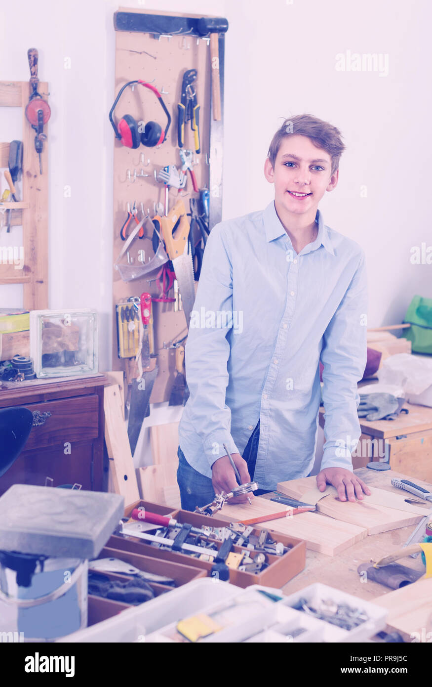 happy young american pupil working with wood plank in class Stock Photo ...