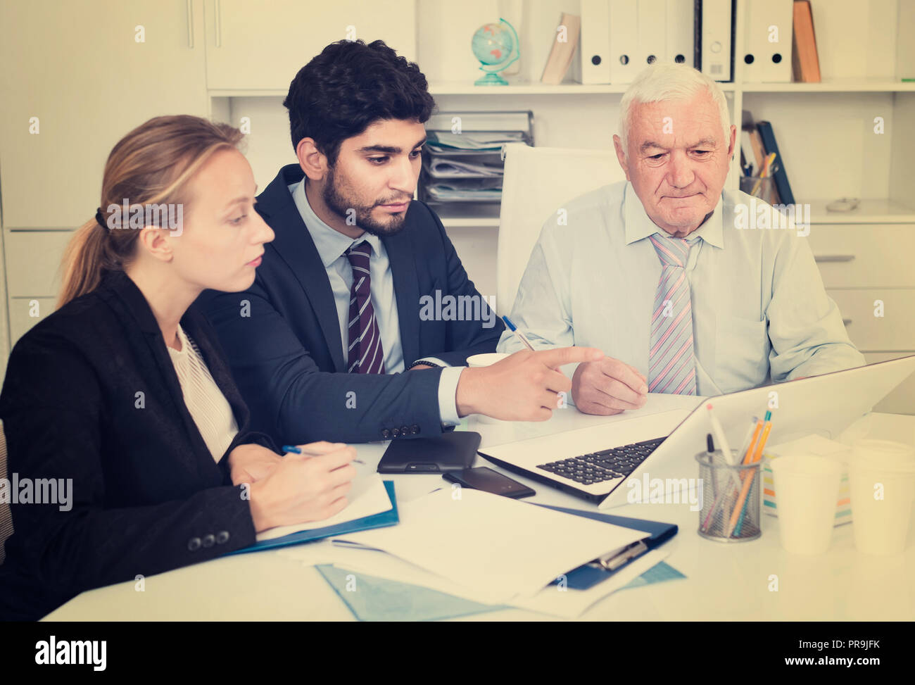 Employees are working together at computer in the office Stock Photo ...