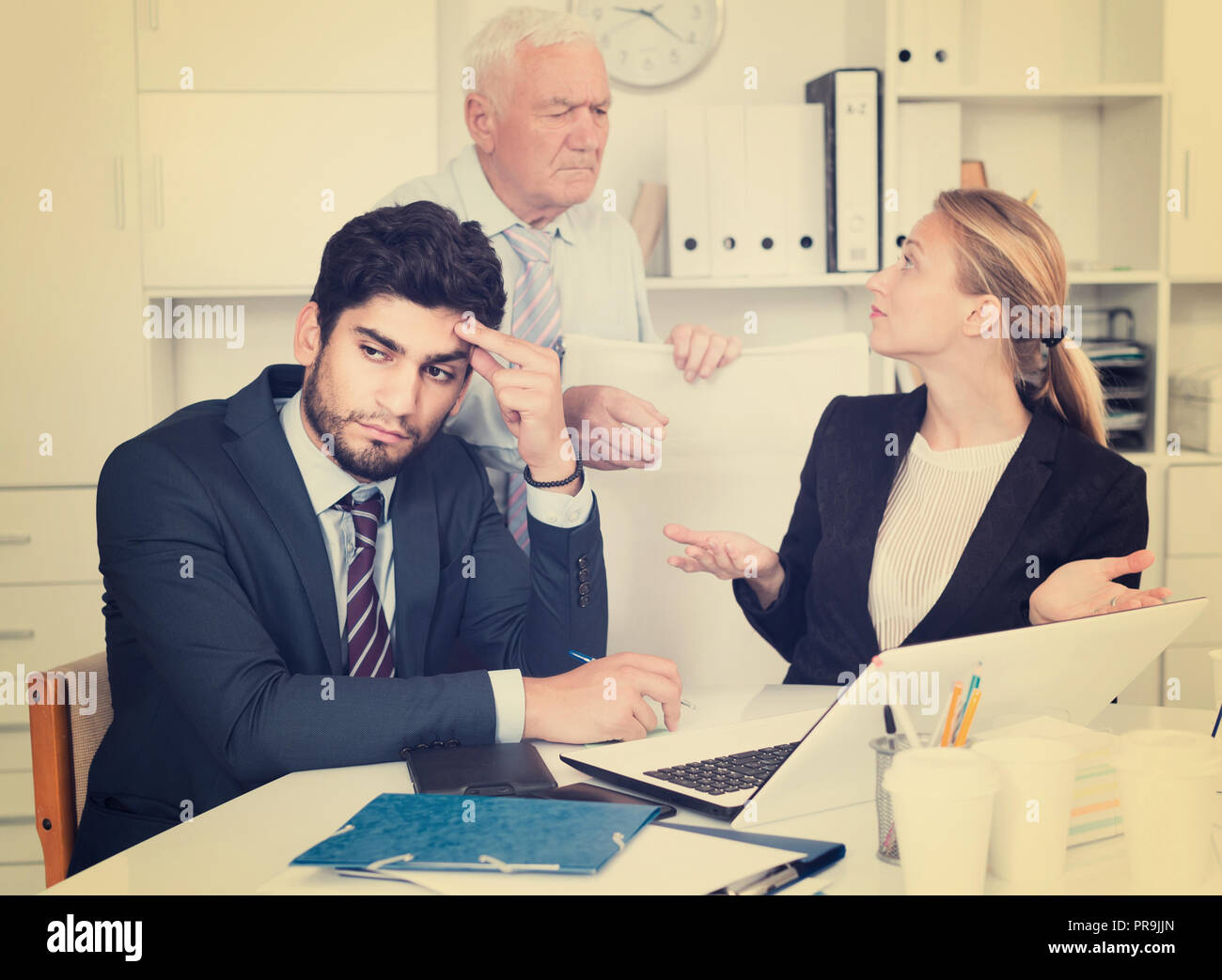 Mature businessman is chastising employees because of uncompleted work ...