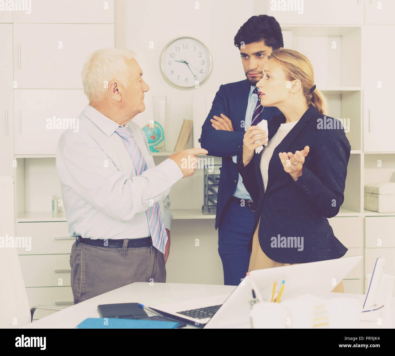 Mature businessman is chastising employees because of uncompleted work ...