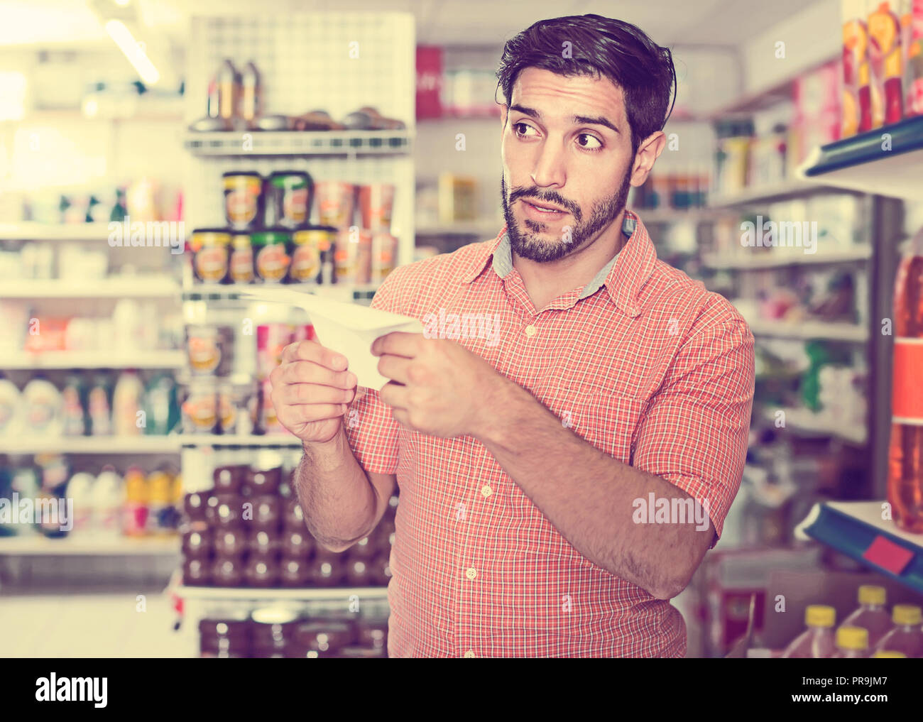 Portrait of handsome man customer who is standing with note list in ...