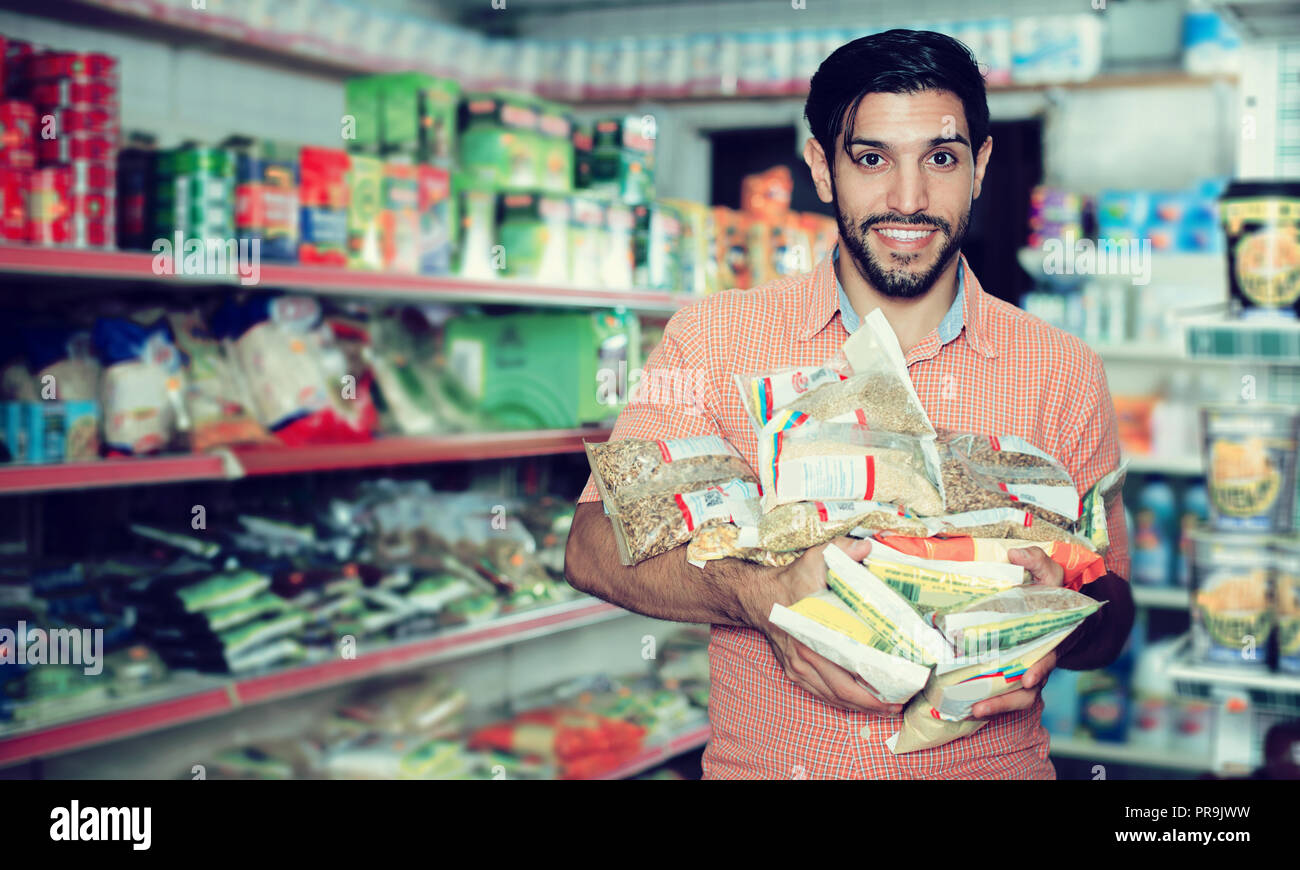 smiling customer who is standing with note list and talking phone in ...