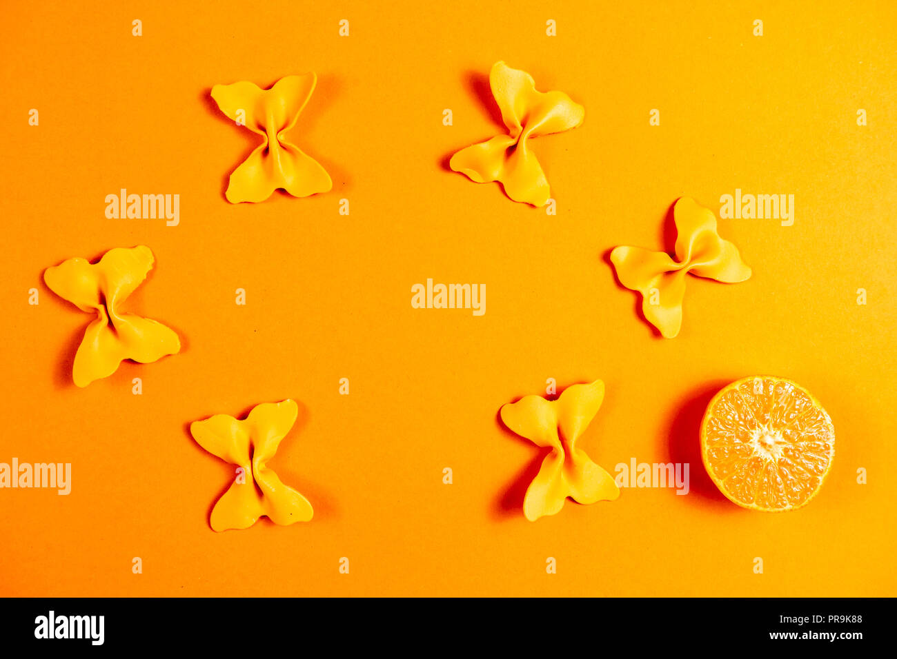 Creative summer layout made of clementines and colored pasta semolina ...