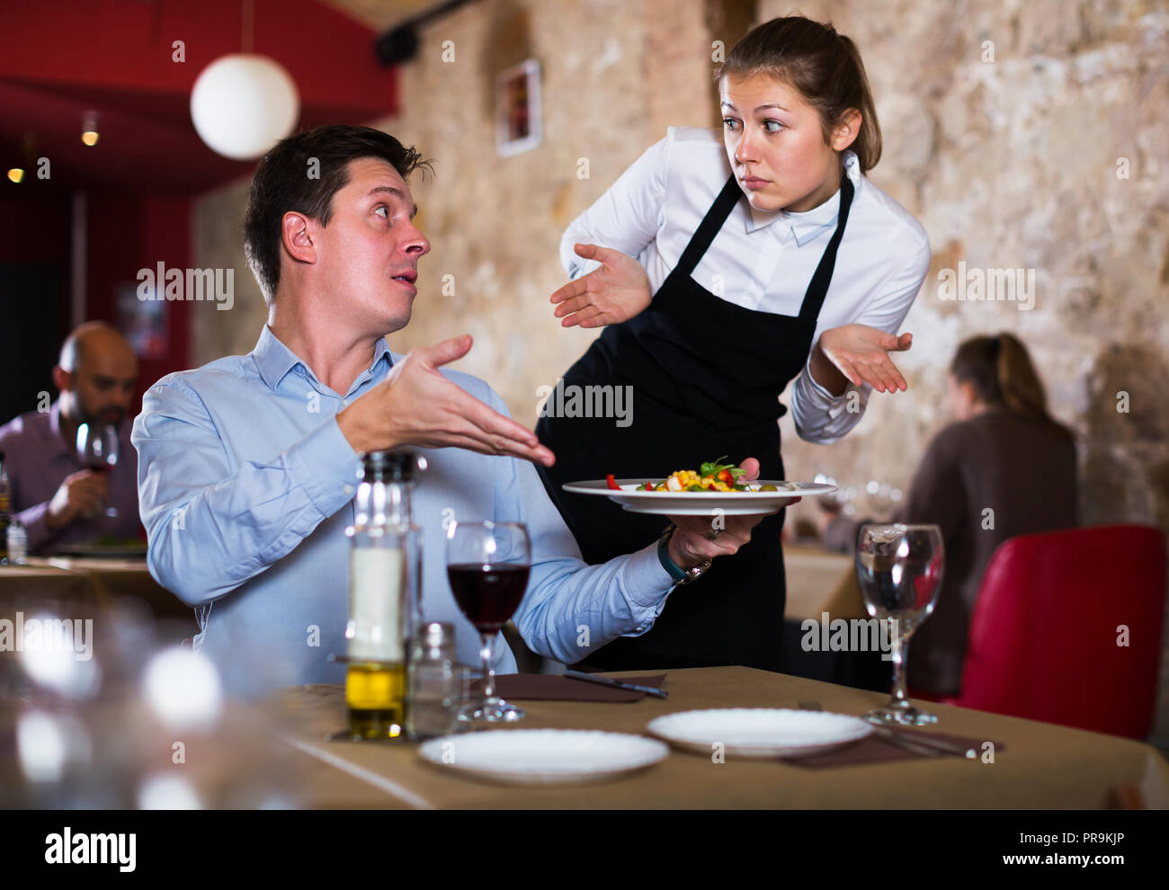 Dissatisfied man expressing displeasure with food talking to excusing ...