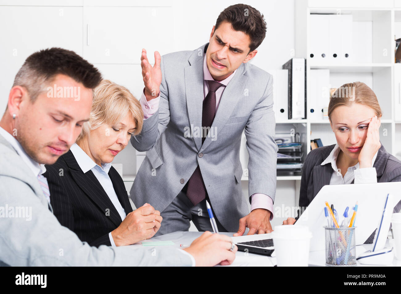 Outraged manager expressing dissatisfaction with teamwork of colleagues ...