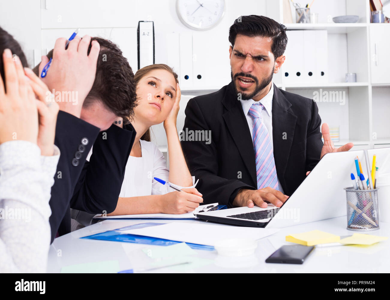 Businessman feeling angry to coworkers in office, pointing out mistakes ...