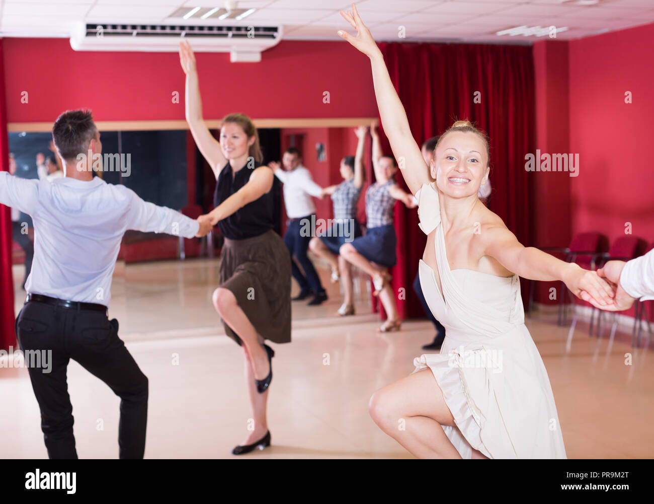 Young positive people dancing rock-and-roll in pairs Stock Photo - Alamy