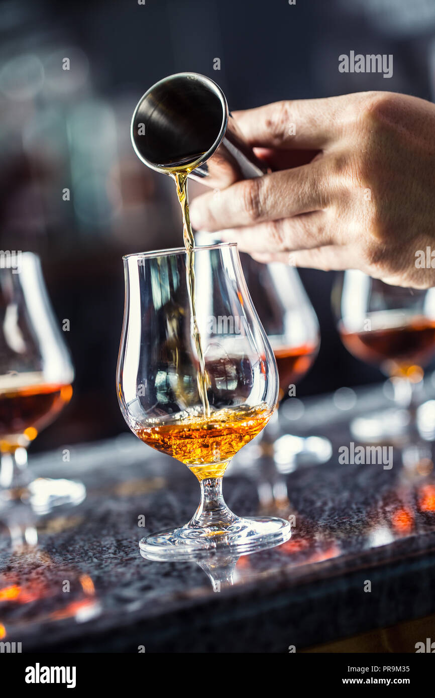Bartender hand pouring alcoholic drink in nightclub, bar or pub Stock ...