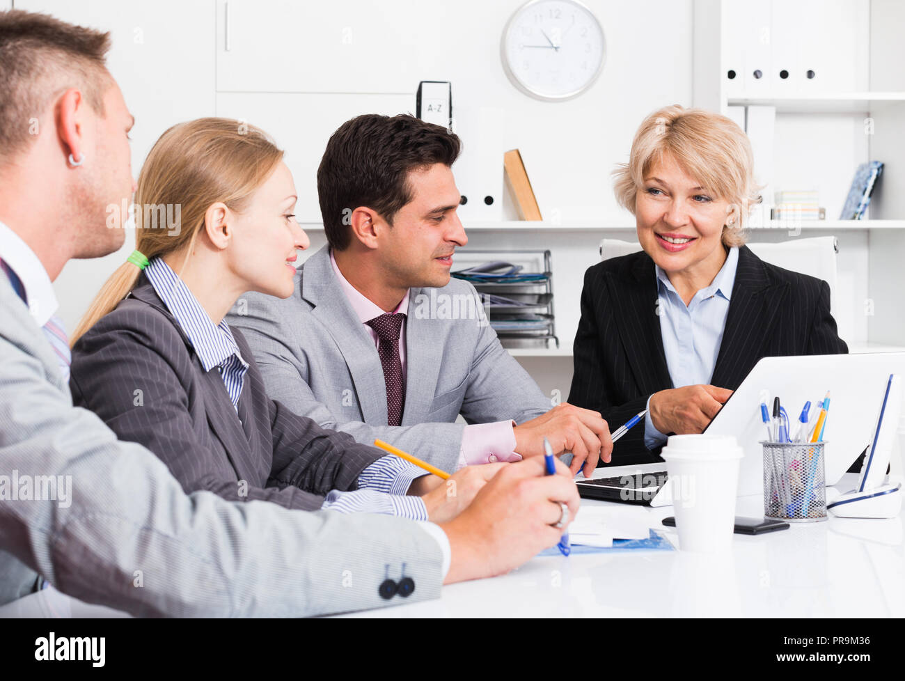 Group of confident business colleagues planning work at joint meeting ...