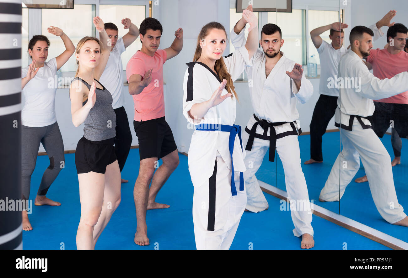 Young american adults attempting to master new moves during karate ...