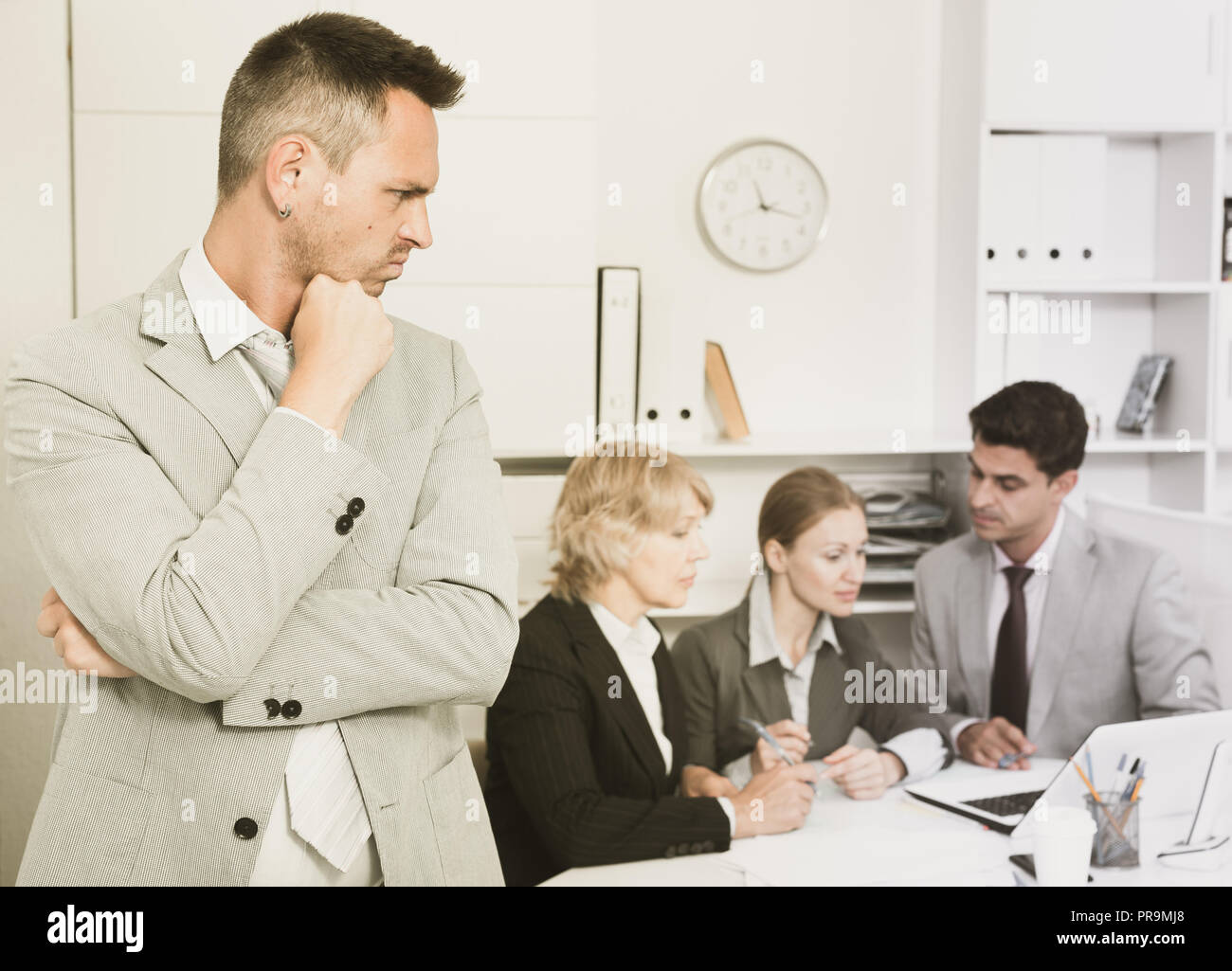 Angry manager standing in office dissatisfied with teamwork of ...