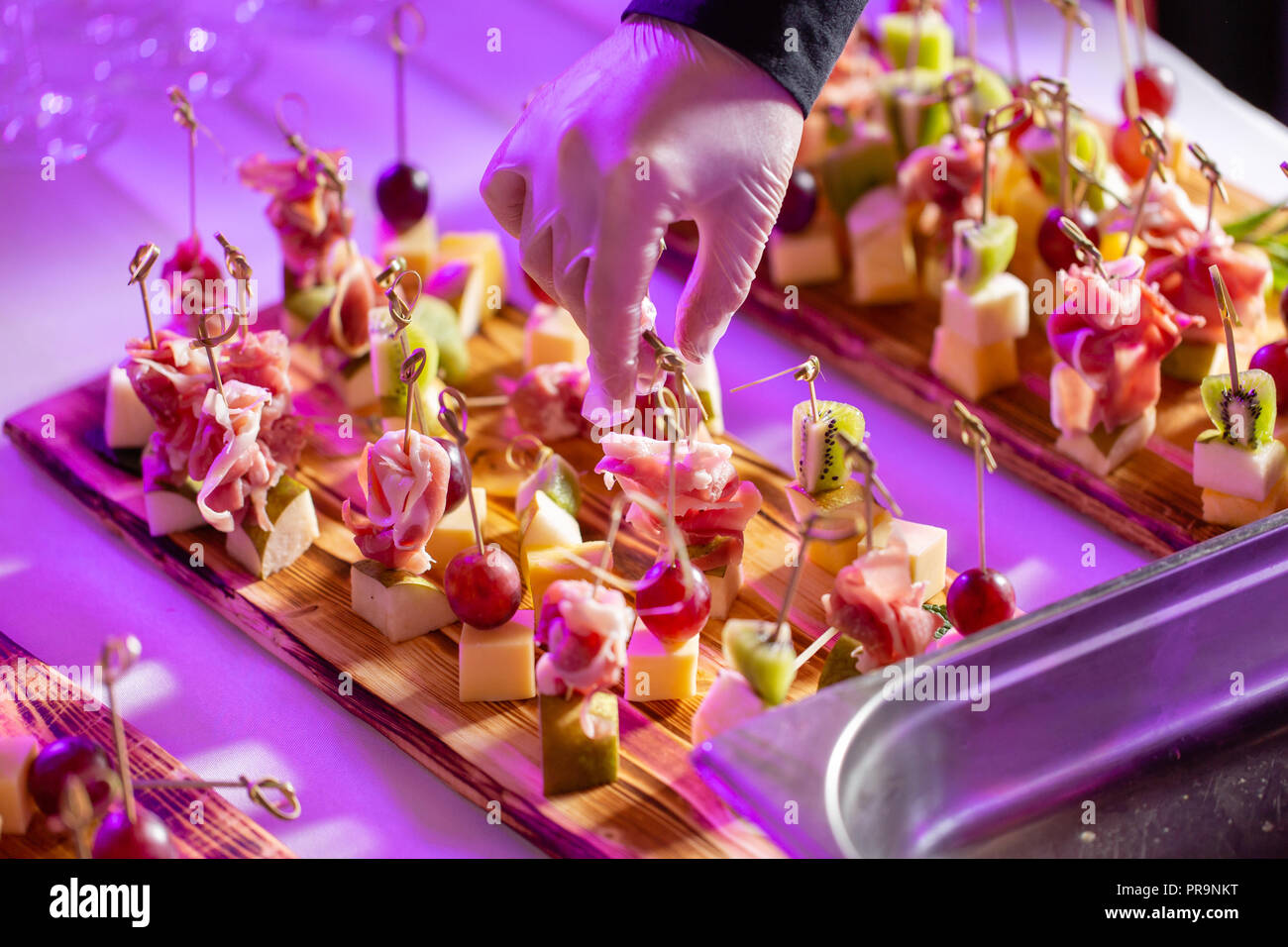 The waiter prepared and serves a snack. the buffet at the reception ...