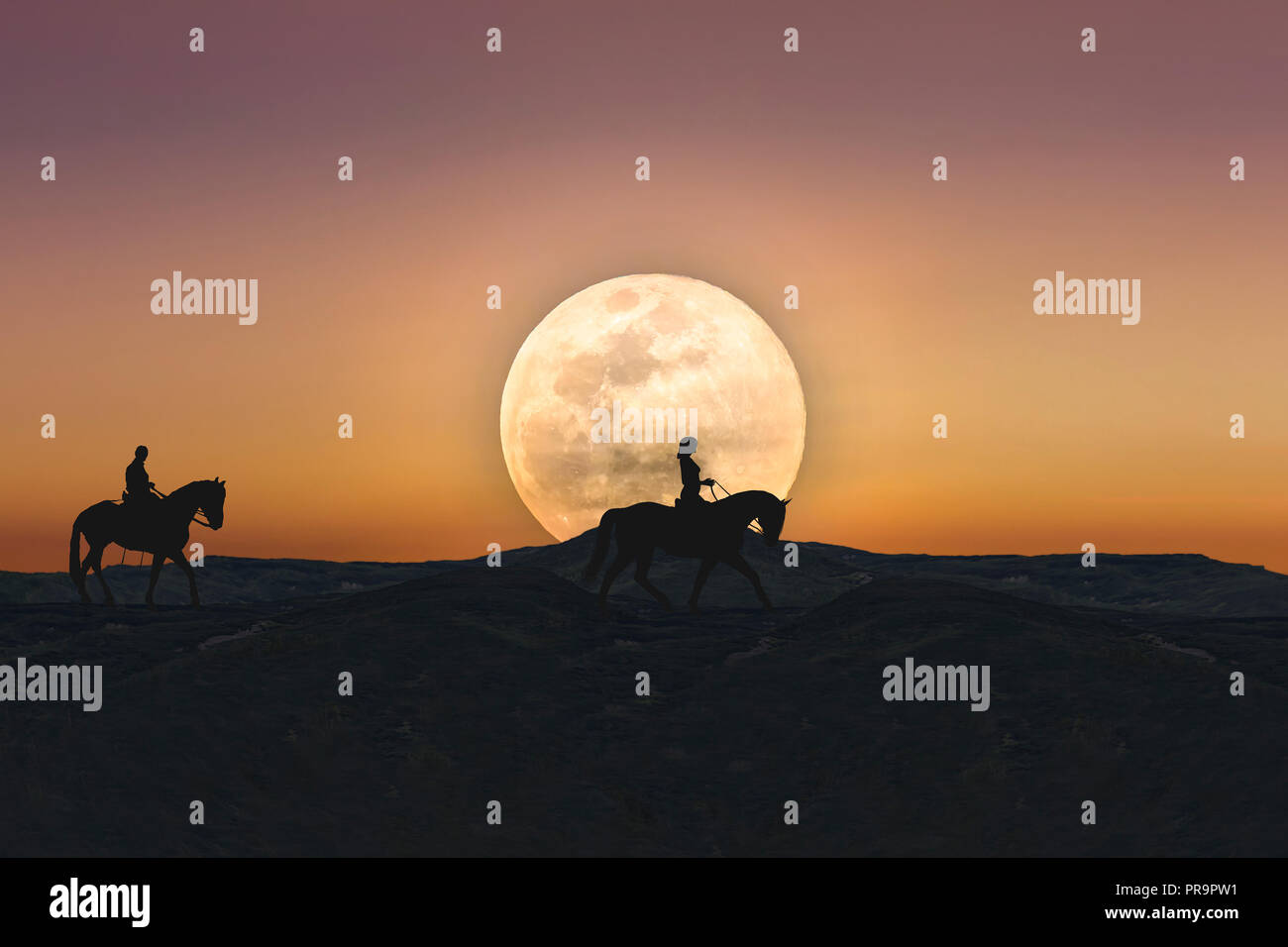 Silhouette of man and woman riding horse across horizon while the full ...