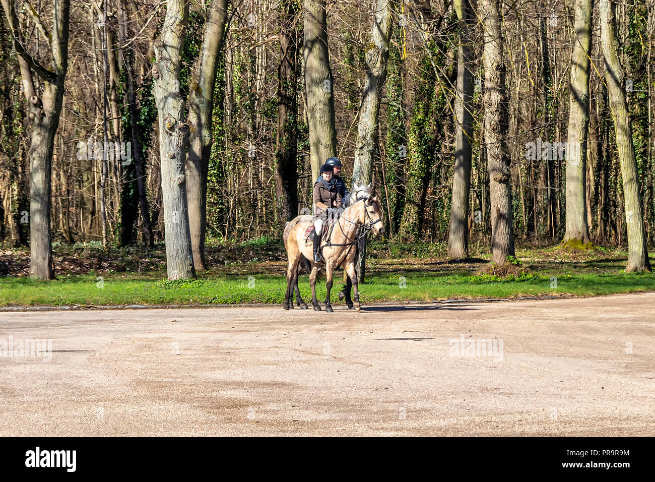 Woman riding the horse in the gardens of Versailles palace in Paris ...