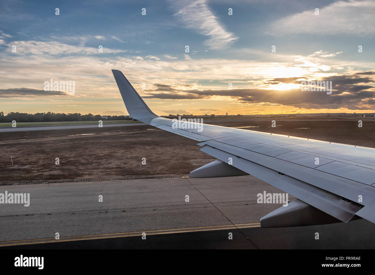 Airplane window view showing wing of the plane while has been landed ...