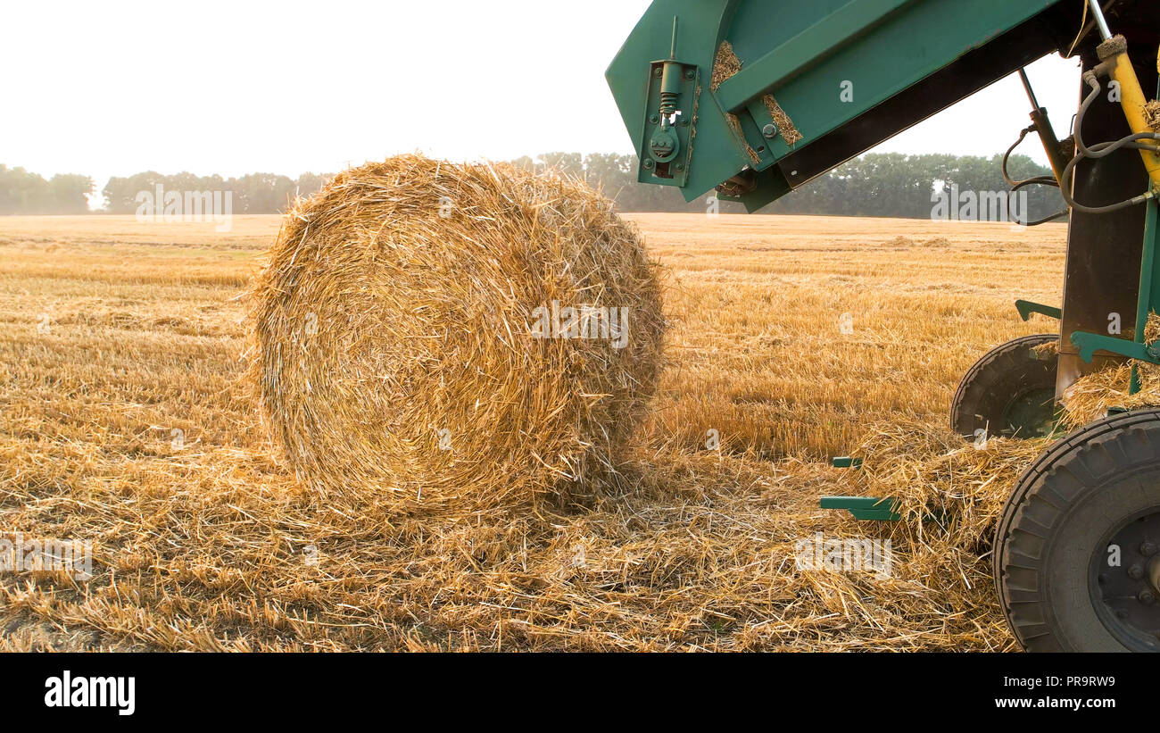 Hay bale making machine Stock Photo - Alamy
