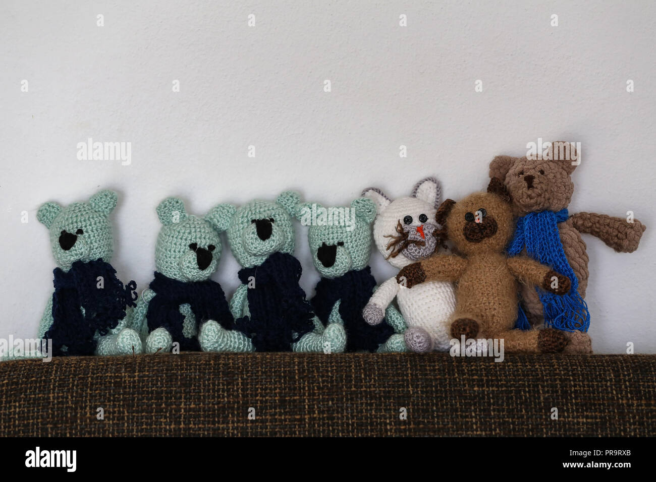 Homemade knitted toys stand against the wall Stock Photo - Alamy