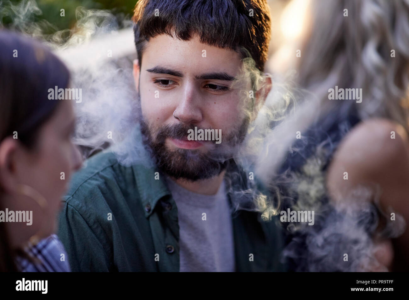 people smoking using vape happing pens in Manchester Stock Photo - Alamy