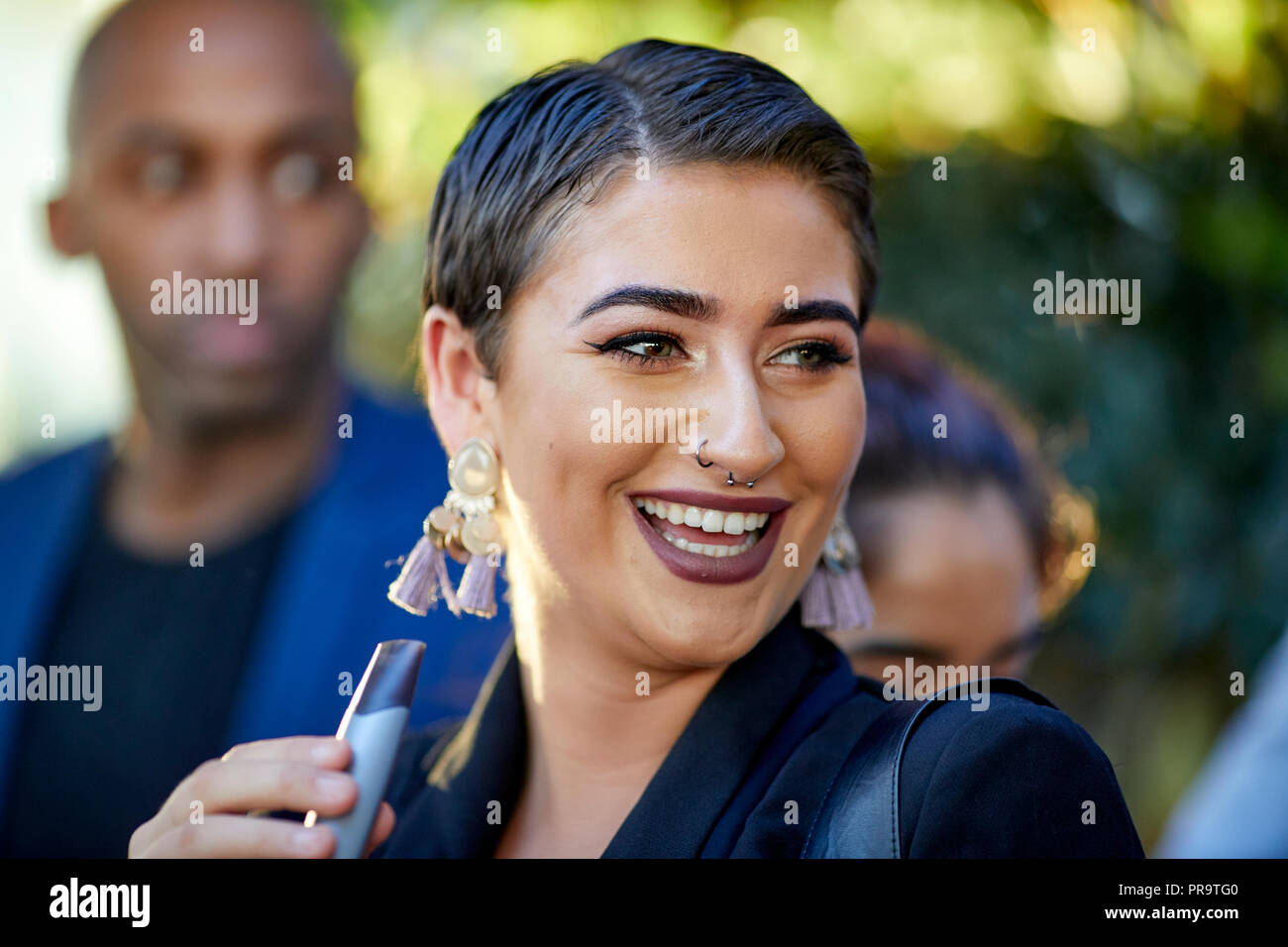 people smoking using vape happing pens in Manchester Stock Photo - Alamy