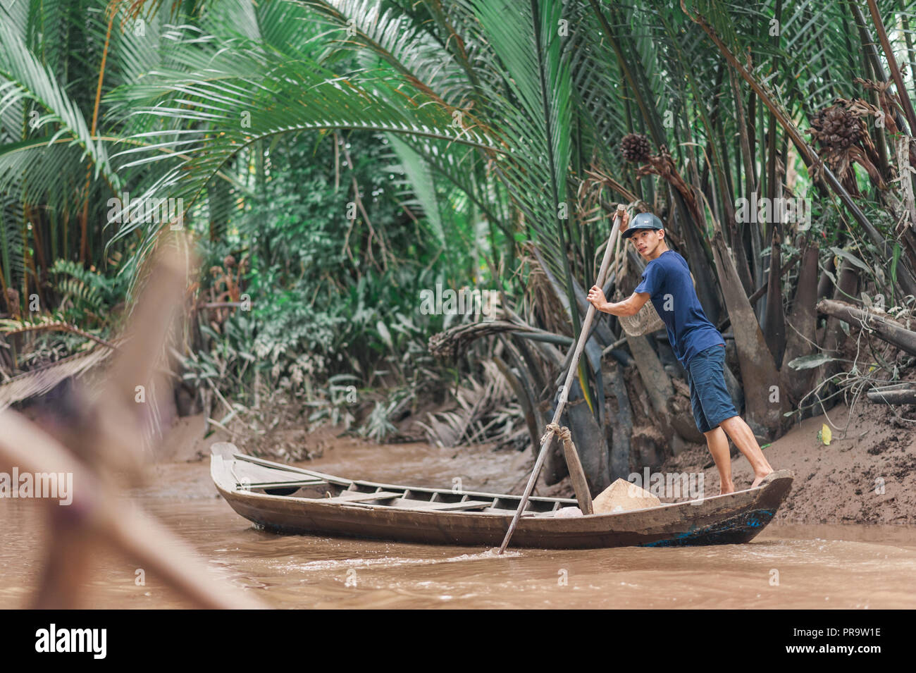 Mekong Delta, Ben Tre, Vietnam - October 21, 2016. Local man rowing a ...