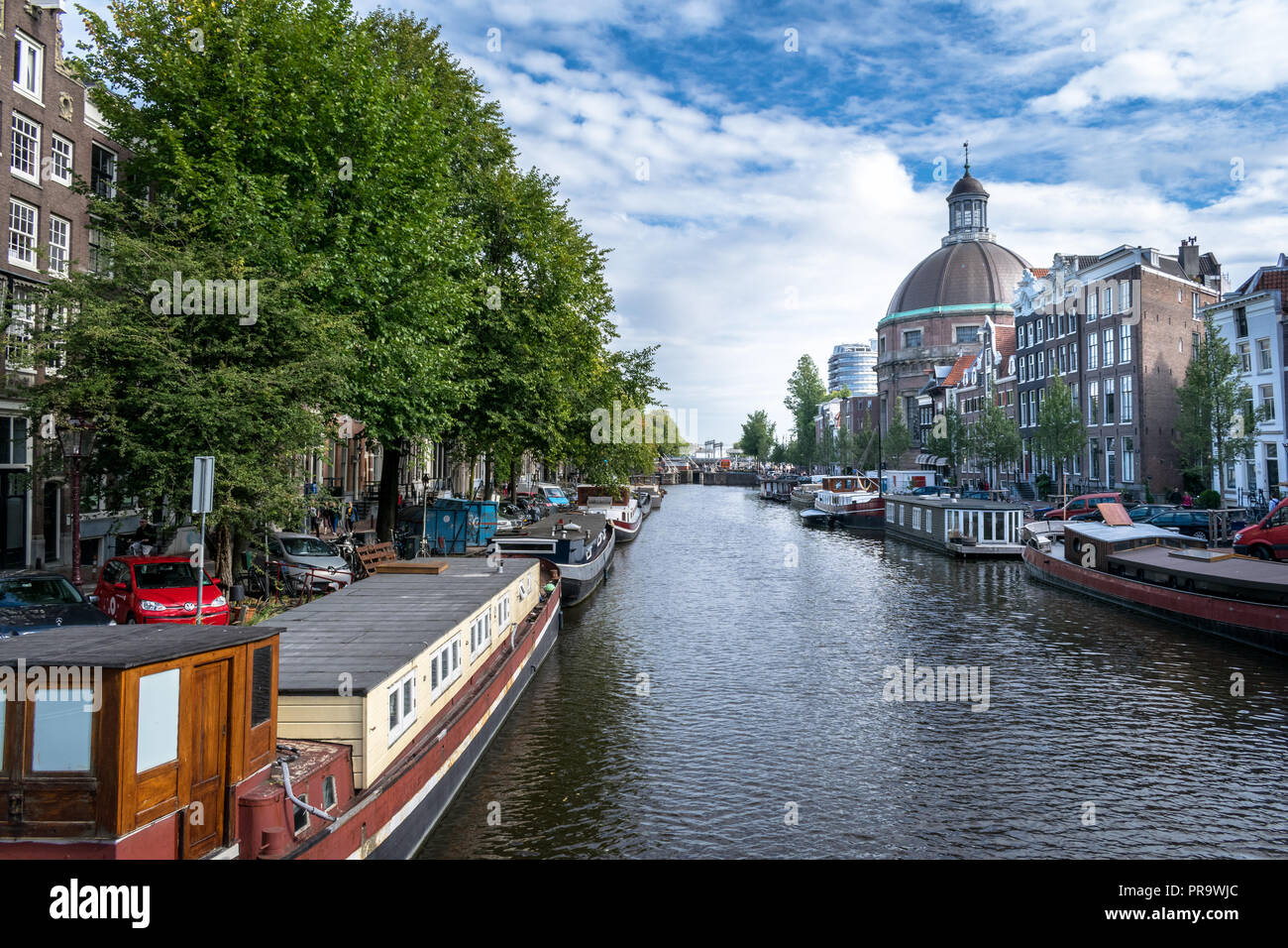 This is a picture of boats lined up along on of Amsterdams Canals Stock ...