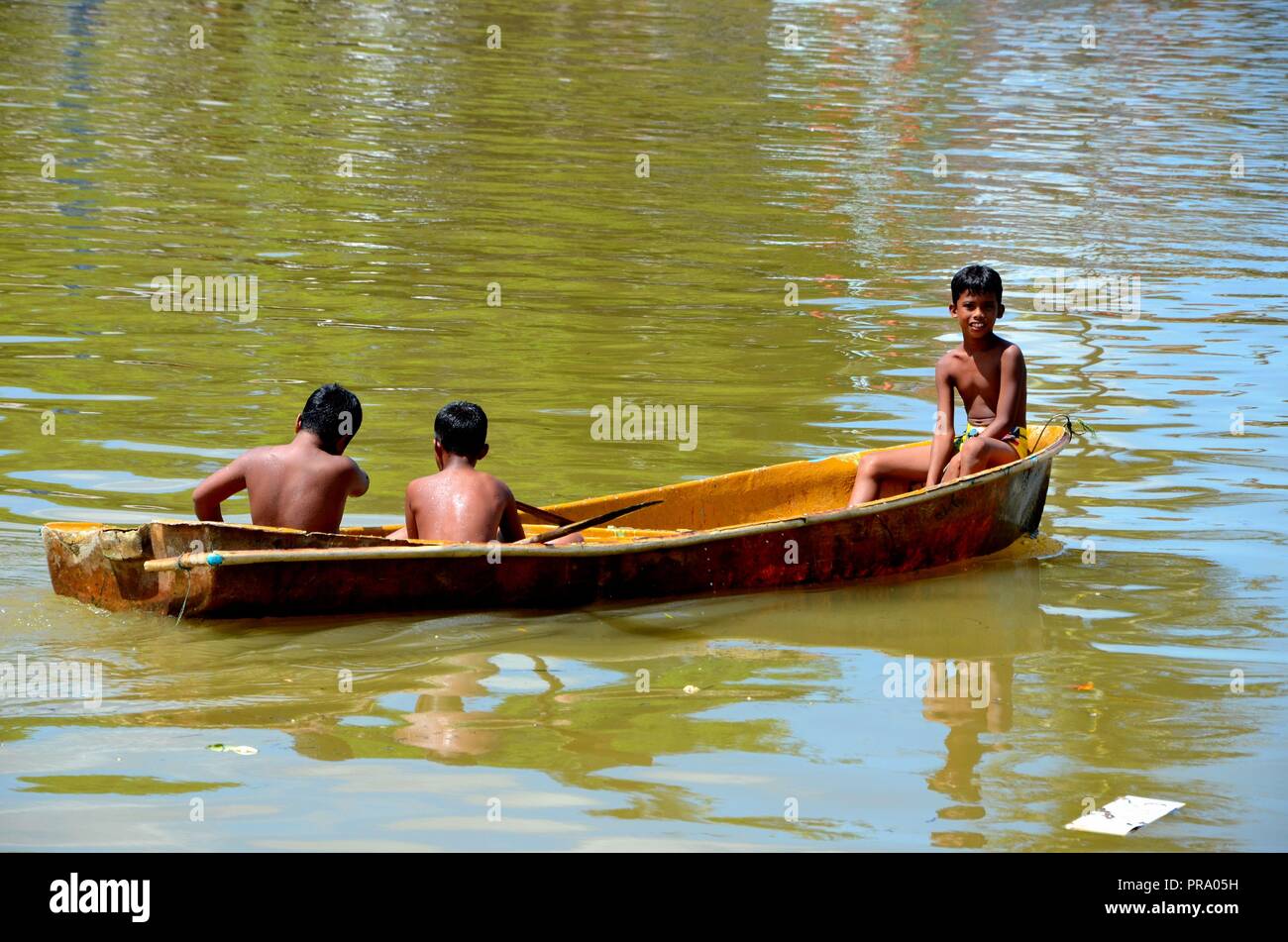 Thai boys on boat in fish harbor Pattani Thailand Stock Photo - Alamy