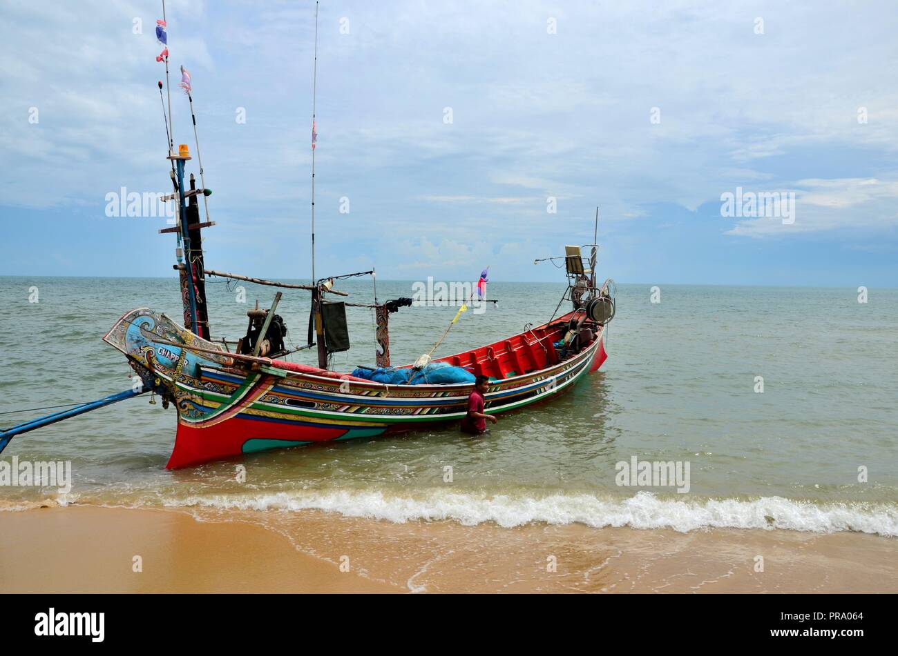 Sea going fishing vessel boat parked on beach in Pattani village ...