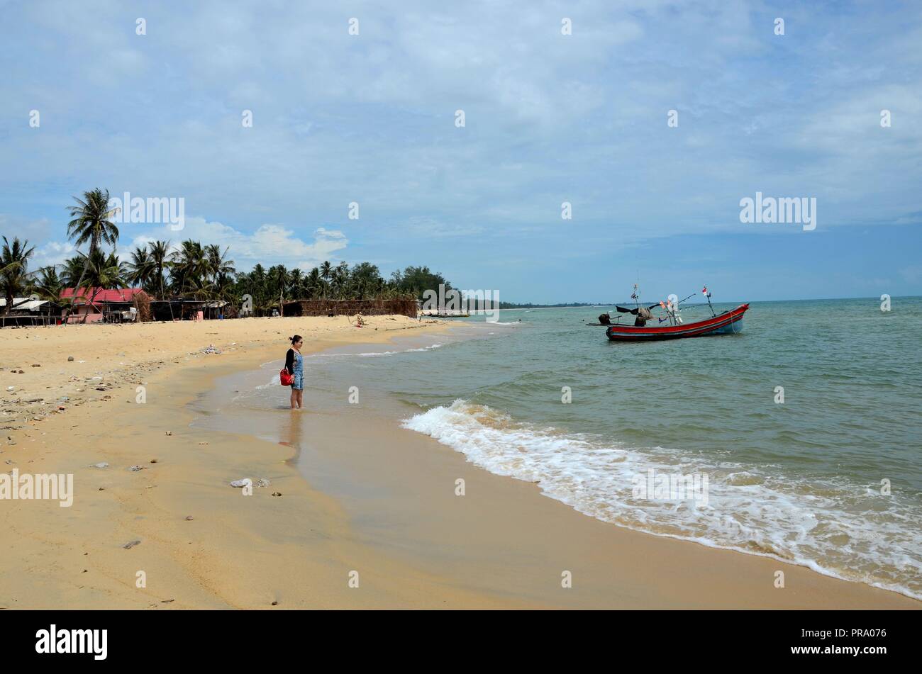 Chinese woman wades in water at tropical beach Pattani Thailand Stock ...