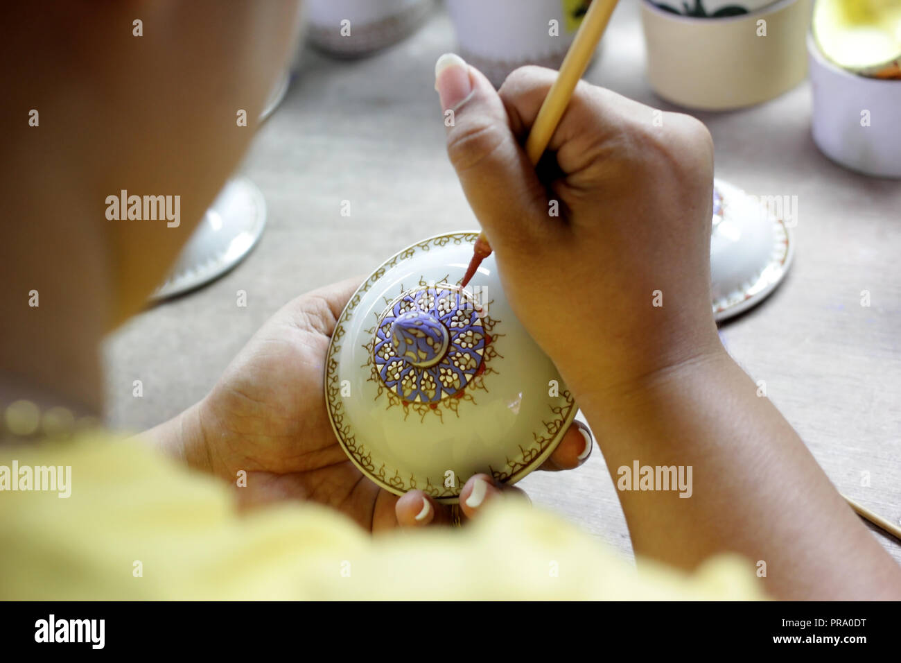 artist painting benjarong ceramic ware , A traditional Thai five ...